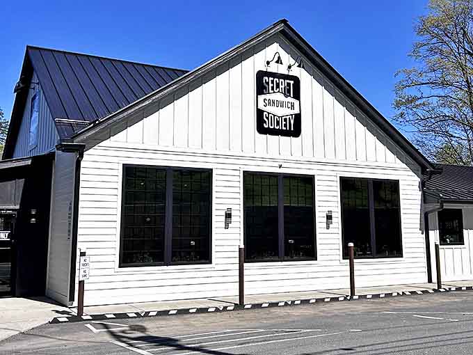 Clean lines and classic charm define this renovated building, where the black and white sign promises secrets worth discovering. Spoiler alert: they involve pimento cheese.