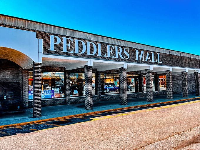 The brick facade of Peddlers Mall stands like a treasure chest waiting to be unlocked, its bold red lettering a siren call to bargain hunters across West Virginia.
