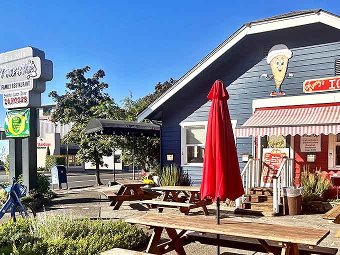 The blue exterior of Mandy's welcomes hungry travelers with its cheerful ice cream cone mascot and inviting wooden picnic tables. Oregon sunshine optional, appetite mandatory.