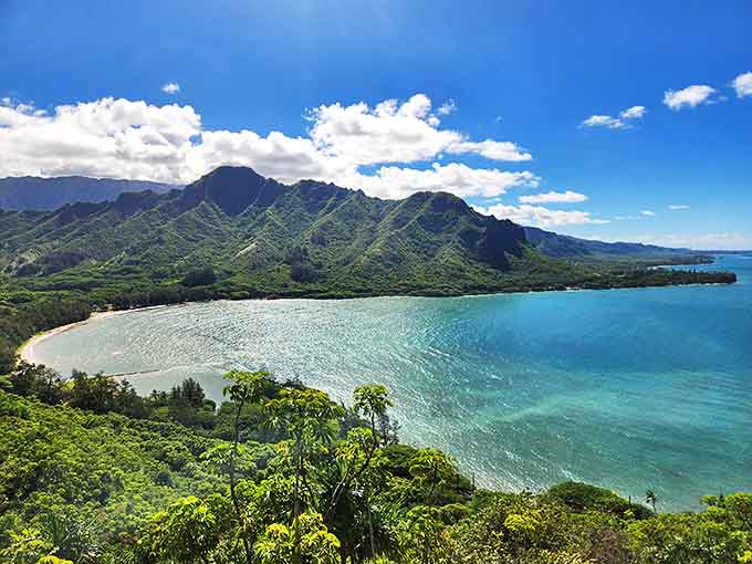 The crescent-shaped Kahana Bay embraces turquoise waters while the majestic Koʻolau Mountains create nature's perfect amphitheater.