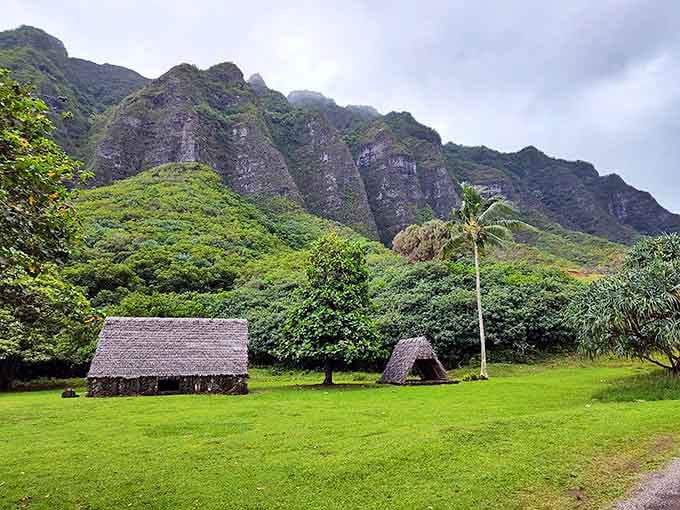 Traditional Hawaiian structures nestle at the mountain's feet, offering glimpses into the ahupuaʻa's living cultural heritage.