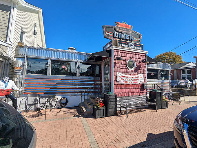 Under clear blue skies, Broad Street Diner's vintage neon sign stands proud against modern surroundings. Like finding a perfectly preserved vinyl record in a world of digital downloads.