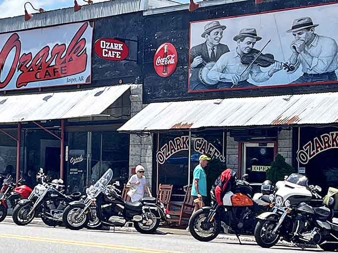 The iconic red signage of Ozark Cafe stands proudly alongside a mural of musicians, while motorcycles line up outside like hungry patrons waiting their turn.