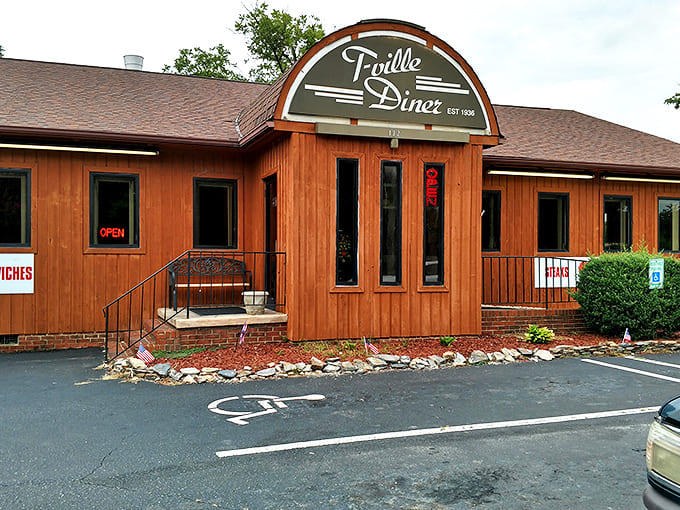The wooden exterior of T-Ville Diner stands like a culinary time capsule, promising comfort food that predates your smartphone addiction.