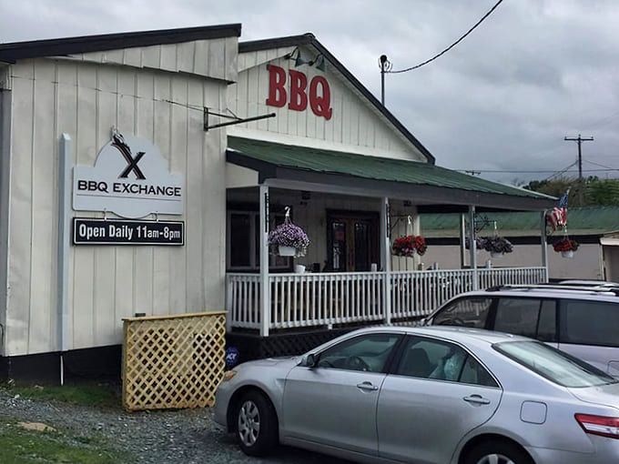 The white clapboard building with "BBQ" on the roof isn't trying to be fancy—it's too busy perfecting what's smoking inside.