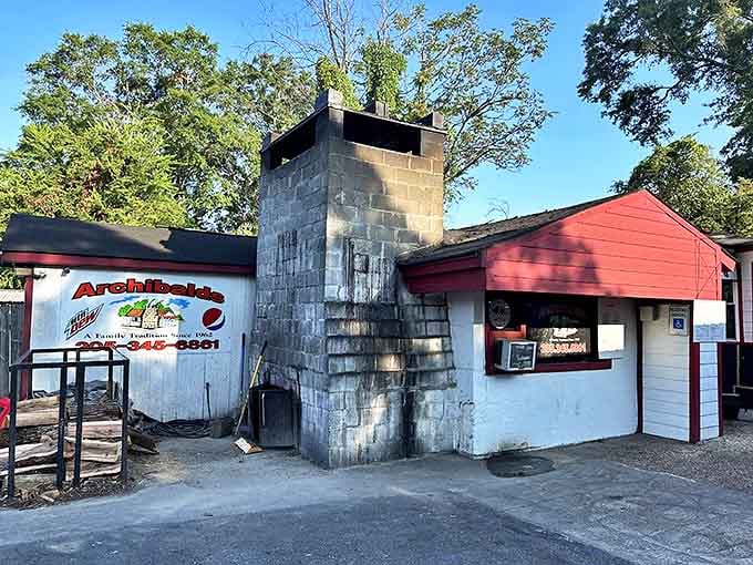 That towering chimney isn't just for show &ndash; it's the smoke-belching heart of Archibald's barbecue magic, standing sentinel over decades of delicious tradition.