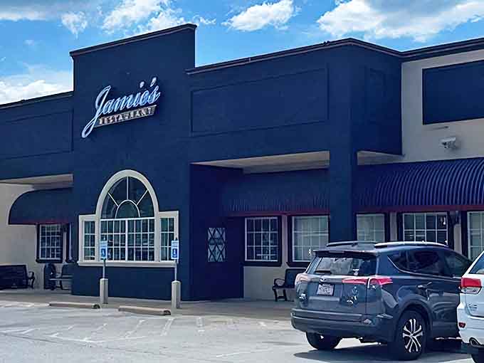 Jamie's distinctive navy blue exterior welcomes hungry patrons with its illuminated sign and inviting arched window&mdash;breakfast paradise awaits inside.