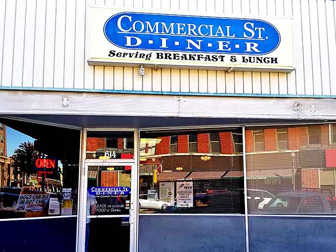 That iconic blue oval sign against the white clapboard exterior is like a beacon for hungry travelers—no fancy frills, just the promise of honest food.