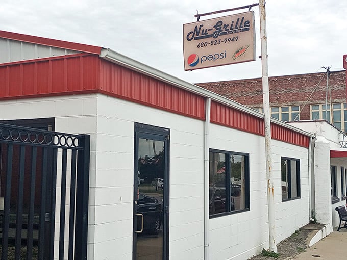 That classic red and white exterior isn't trying to impress anyone—it's too busy housing some of the best diner food in the Sunflower State.