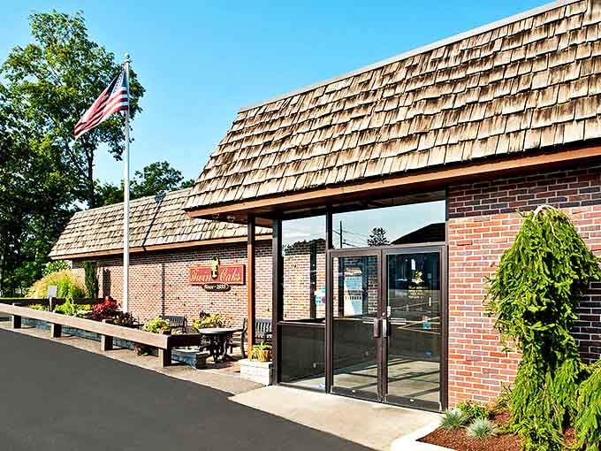 The classic brick exterior of Twin Oaks stands proudly under Rhode Island skies, an American flag waving as if to say "come hungry, leave happy."