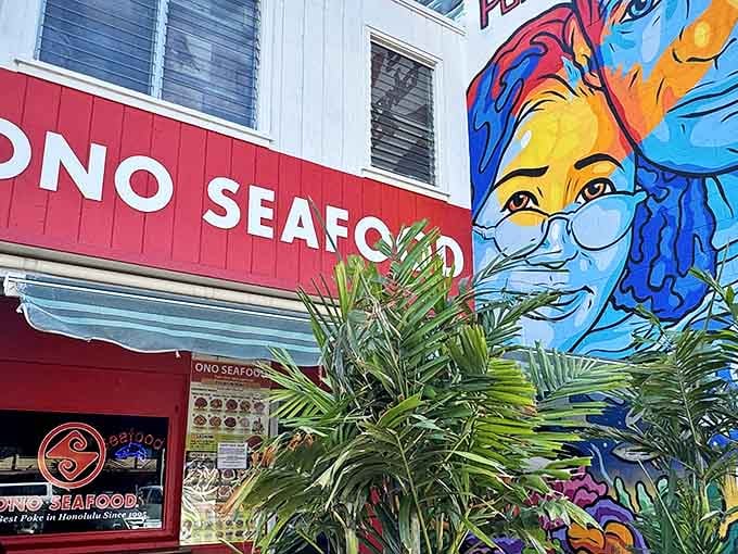 The vibrant red exterior of Ono Seafood stands out like a beacon of deliciousness on Kapahulu Avenue, promising seafood treasures within.