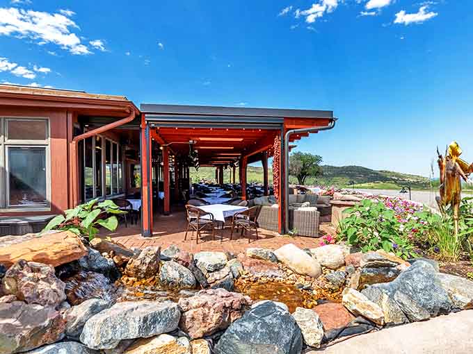 Dine al fresco on The Fort's stunning patio where mountain views compete with culinary masterpieces for your attention. The trickling water feature isn't just for show.