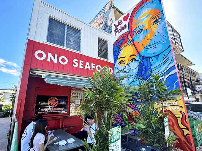 Tropical palms frame Ono Seafood's iconic red and white exterior, where Hawaii's best poke awaits behind a humble storefront.