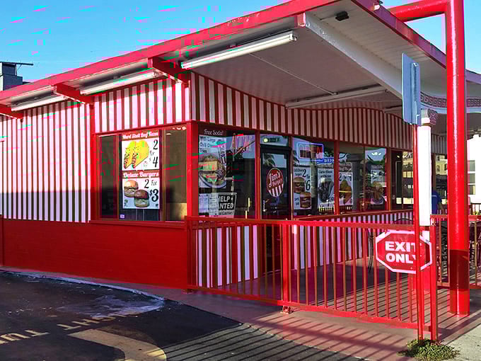 The iconic red and white striped exterior of Jim's Burgers stands as a beacon of affordable deliciousness in Long Beach's fast-food landscape.