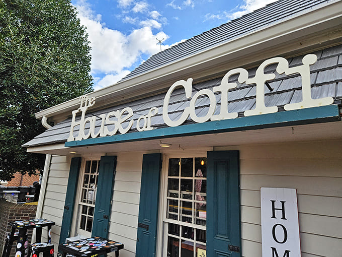 The charming exterior of House of Coffi beckons with its cream siding and brick borders—like a coffee oasis in downtown Dover.
