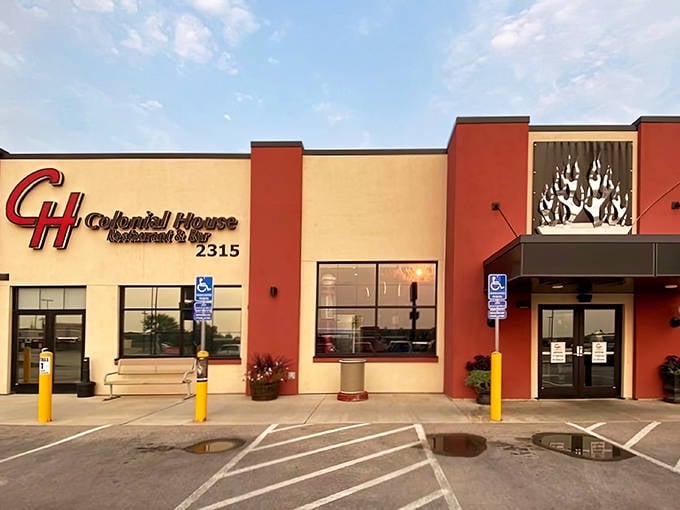 The iconic red-accented facade of Colonial House stands like a beacon for hungry travelers on Mount Rushmore Road.