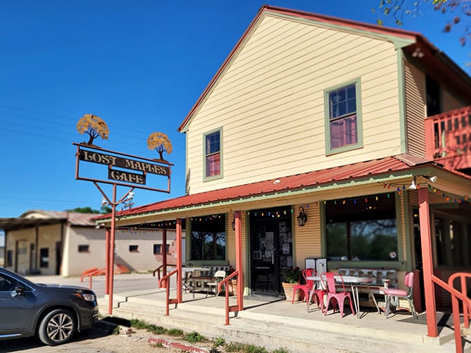 The charming exterior of Lost Maples Cafe in Utopia, with its iconic sign and welcoming porch beckoning hungry travelers.