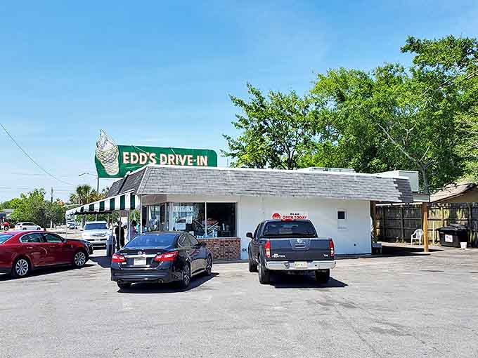 The iconic green and white striped awning of Edd's Drive-In stands as a beacon of burger bliss in Pascagoula, where time seems to slow down just enough to savor every bite.