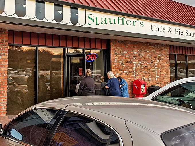 The morning pilgrimage begins! Locals know to arrive early at Stauffer's, where the red awning and neon "OPEN" sign beckon like an old friend waving you in.