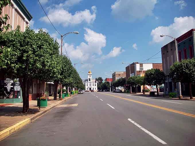 Tree-lined streets lead to the iconic courthouse, creating a postcard-perfect scene that doesn't require a postcard-perfect budget to enjoy.