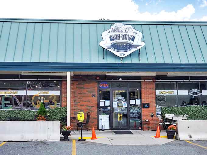 The unassuming exterior of Iron Town Diner in Saugus &ndash; where breakfast dreams come true beneath that classic diner signage.