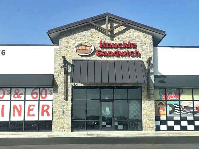 The Knuckle Sandwich's distinctive exterior combines rustic stonework with retro diner aesthetics, promising a nostalgic culinary journey inside.