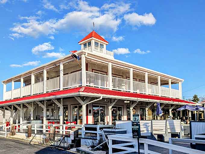 The iconic red-roofed Wheelhouse stands like a maritime lighthouse for hungry souls, promising seafood treasures within its distinctive coastal architecture.