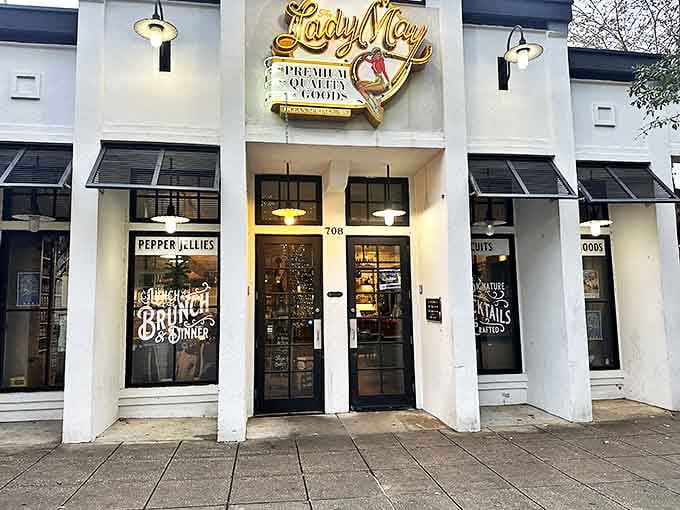 Lady May&rsquo;s illuminated storefront welcomes early visitors like a beacon, inviting hungry souls to enjoy coastal charm blended with urban style in Ocean Springs.