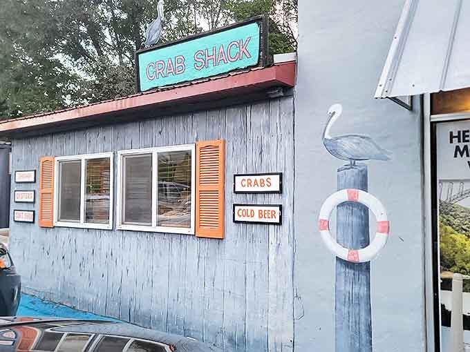 The weathered wood siding and bright turquoise "CRAB SHACK" sign create that perfect "we found a hidden gem" moment every food adventurer lives for.