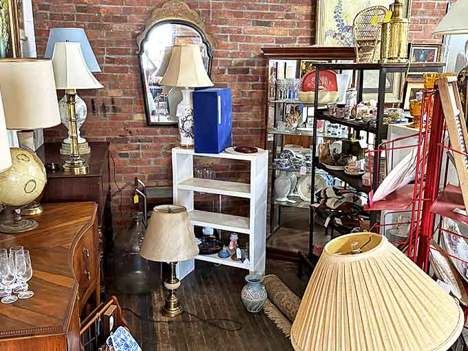 Exposed brick walls create the perfect backdrop for this eclectic collection of lamps, mirrors, and furnishings. Somewhere in here is the conversation piece your living room has been missing.