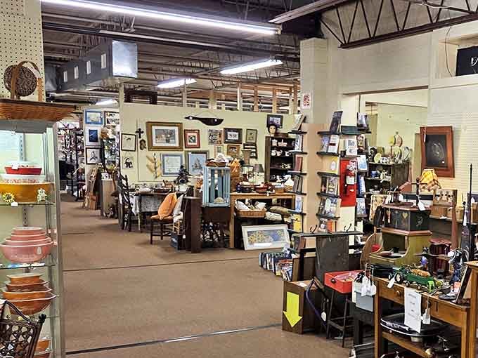 Winding aisles of vendor booths create a labyrinth of treasures, from vintage kitchenware to framed artwork and collectibles.
