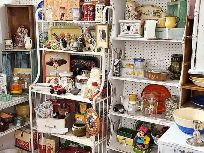 Kitchen collectibles from grandma's era stand at attention, each shelf a time capsule of domestic life through the decades.