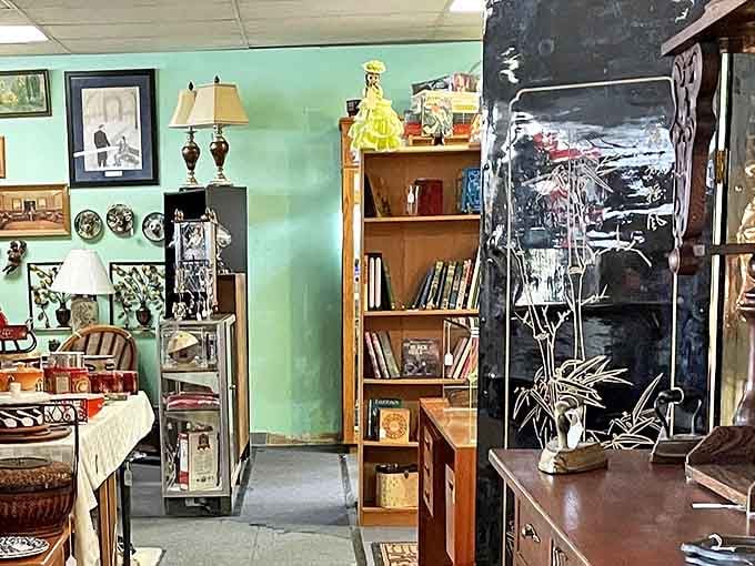 Vintage lamps, framed photographs, and carefully arranged furniture create cozy vignettes within the sprawling antique marketplace.