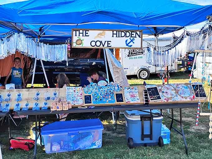 "The Hidden Cove" vendor displays ocean-themed crafts and souvenirs, bringing coastal charm to this mountaintop marketplace.