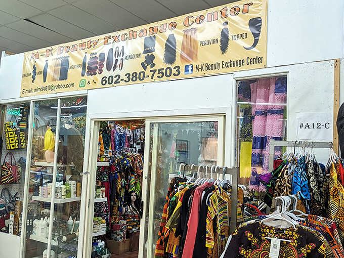 A vibrant vendor stall showcases colorful cultural garments and accessories. Shopping here is like a passport stamp without leaving Arizona.