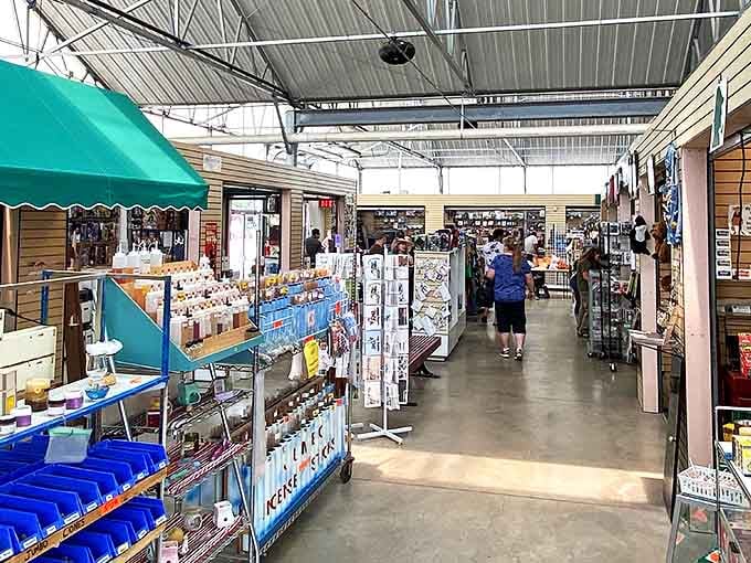 Shoppers browse the covered indoor section of the Colorado Springs Flea Market, where permanent stalls offer everything from collectibles to everyday essentials.