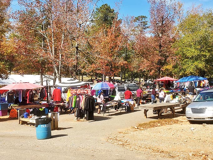 Fall foliage creates a picturesque backdrop for J&J's outdoor vendors, where clothing and household items spill from tables under colorful tents.