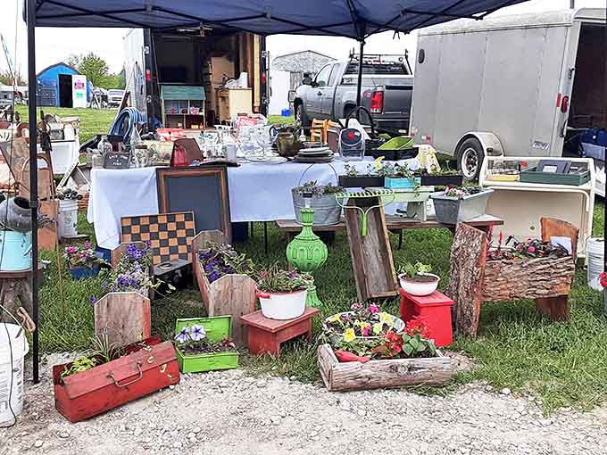 Tables laden with collectibles stretch toward a red building—treasure hunting at its finest, where one person's castoffs become another's conversation pieces.