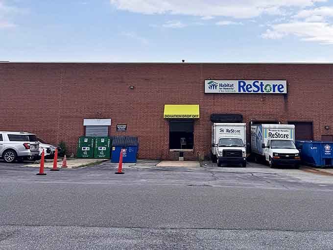 The unassuming brick exterior of Prices Corner ReStore hides a treasure trove within. Like finding the entrance to Narnia, but with more sofas and fewer talking lions.