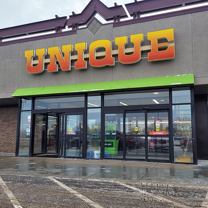 Unique's vibrant orange-to-yellow gradient sign beckons thrifters through its glass doors, where secondhand adventures await just beyond the threshold.