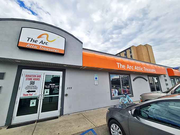 The gray building with its vibrant orange awning stands like a beacon of bargain-hunting hope on Fargo's streets, promising treasures waiting to be discovered inside.
