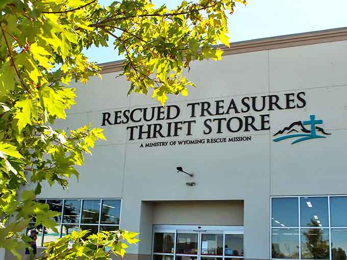 Framed by vibrant green leaves, Rescued Treasures proudly displays its connection to Wyoming Rescue Mission, where shopping meets purpose.