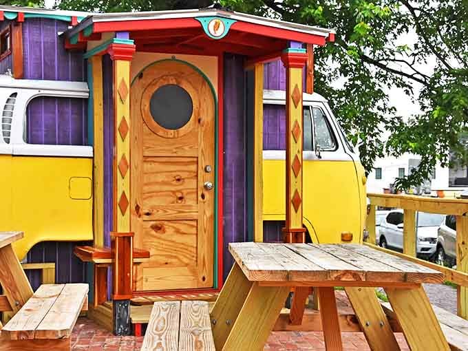 Colorful wooden details and rustic picnic tables create the perfect outdoor dining atmosphere for enjoying gourmet hot dog creations.