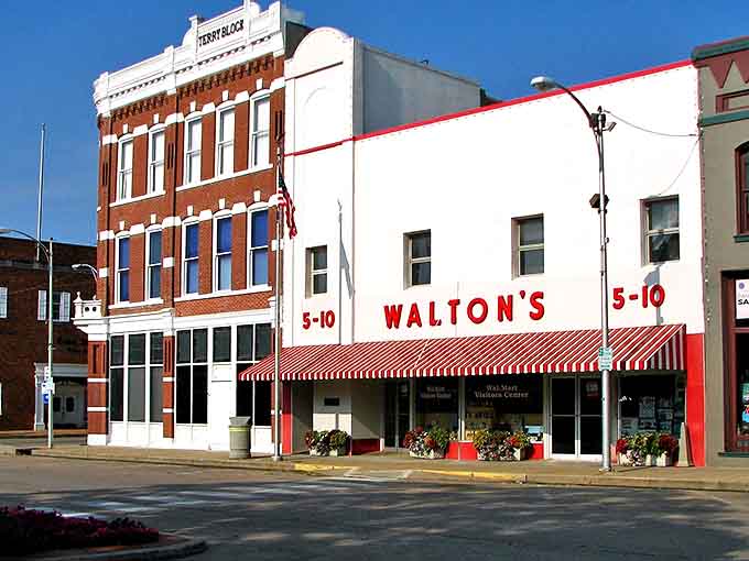 The original Walton's 5-10 store stands as a time capsule of retail history, its iconic red-and-white awning beckoning visitors like a mercantile lighthouse.