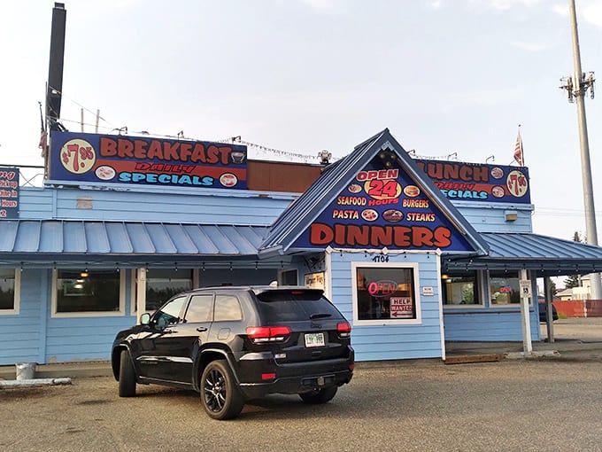 The iconic blue exterior of Airport Way Restaurant stands like a beacon of breakfast hope against the Alaskan sky.