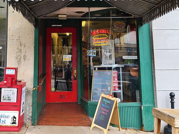 The iconic red door and neon burger sign of Hap's Grill beckon hungry visitors like a culinary lighthouse on Salisbury's Main Street. Behind that humble entrance awaits burger nirvana.