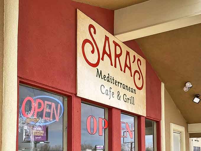 The iconic red-trimmed entrance to Sara's beckons hungry travelers with its welcoming "OPEN" sign &ndash; like a Mediterranean lighthouse in the New Mexico desert.