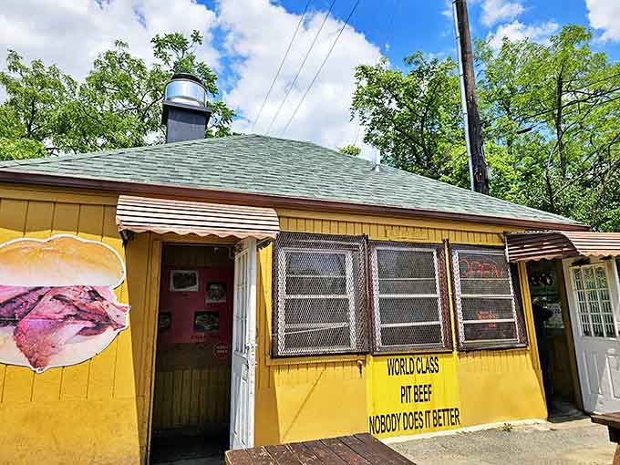 The iconic yellow shack proudly declares "WORLD CLASS PIT BEEF" with a sandwich illustration that promises carnivorous delight to Catonsville visitors.