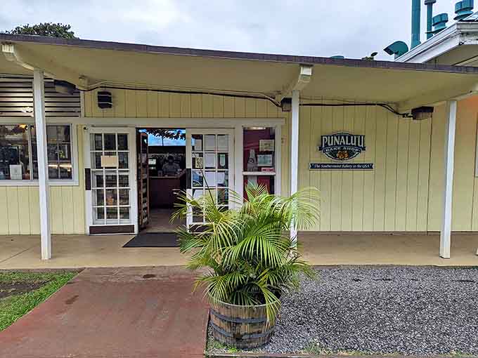 The unassuming yellow facade of Punalu'u Bake Shop stands like a beacon of carb-laden hope in Na'alehu, promising sweet treasures within its humble walls.