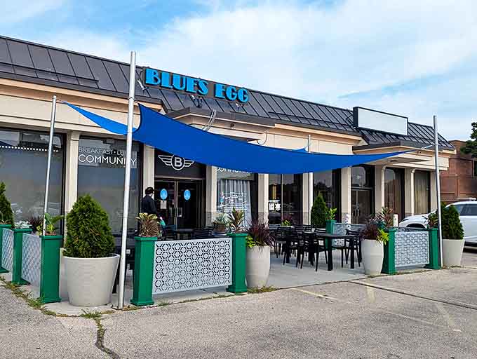 A welcoming blue awning creates the perfect outdoor dining space, where breakfast enthusiasts gather for that first magical coffee sip.